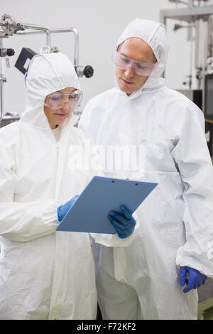 Scientists working with large vat Stock Photo - Alamy