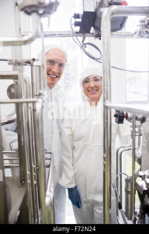 Scientists working with large vat Stock Photo - Alamy