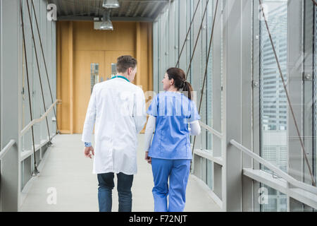 Nurse walking down a hospital hallway Stock Photo - Alamy