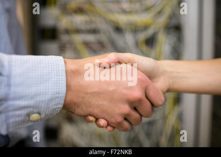 Server room, man or technician shaking hands for hardware maintenance ...
