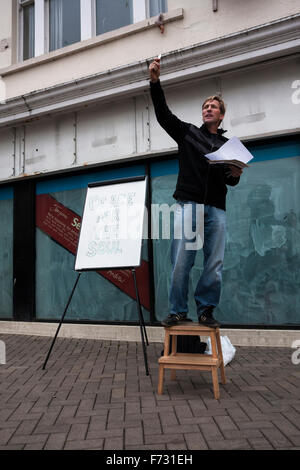 A 'Born Again' Christian man standing on a box preaching on the street ...