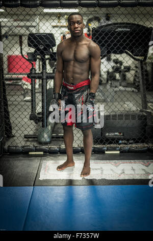 Muscular powerful aggressive man training with rope in functional ...
