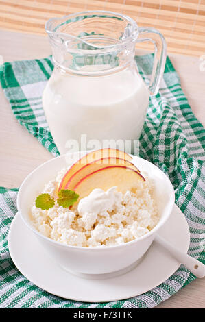 Breakfast, cottage cheese, sour cream banana nuts on a blue wooden ...