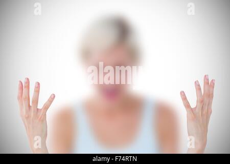 Composite image of angry blonde yelling with hands up Stock Photo - Alamy