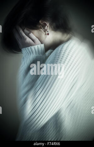 Composite image of sad pretty brunette leaning against wall Stock Photo ...
