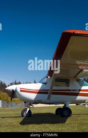 Flight training, small single engine plane ascends into a moody, stormy ...