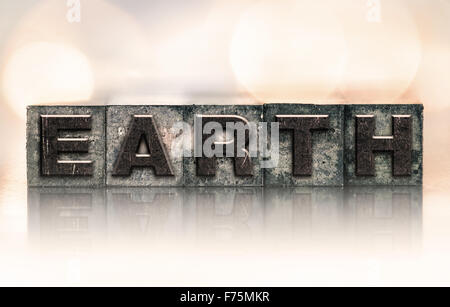 The word "Earth" written in vintage metal letterpress type on a black ...