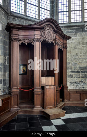 Old Catholic church wooden confession box with open door and green ...