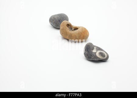 tiny group of pebbles on white Stock Photo - Alamy