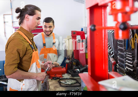 Two workmen toiling at the locksmiths workshop and smiling Stock Photo ...