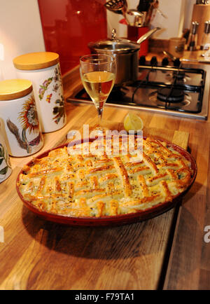 Home made fish pie with a flaky puff pastry lattice topping ready to ...