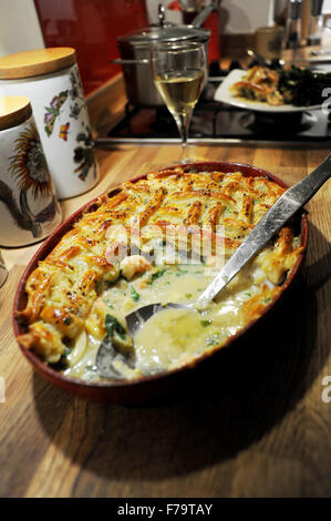 Home made fish pie with a flaky puff pastry lattice topping ready to ...