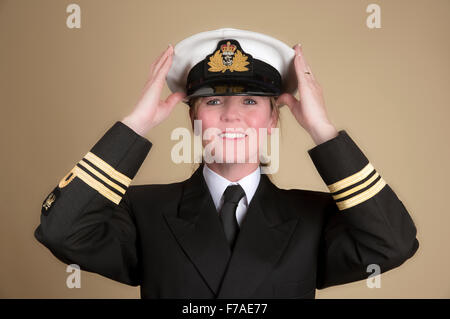 Female senior rank of Lt Commander naval officer holding her uniform ...