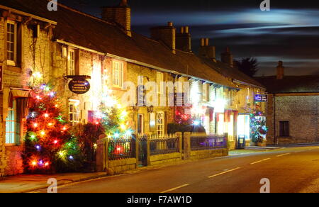 Illuminated Christmas trees line the main street in Castleton; a ...