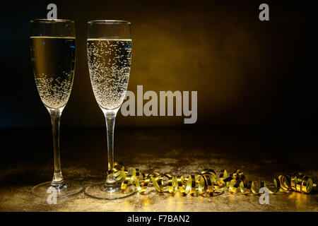 Glasses of champagne and christmas gifts on silver background Stock ...