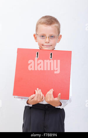 Cute little boy with notebooks showing OK on white background Stock ...