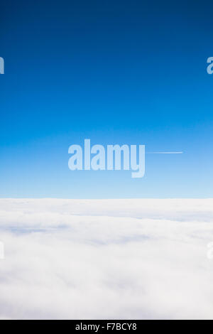 View of the Earth from the airplane flying above the clouds at high ...