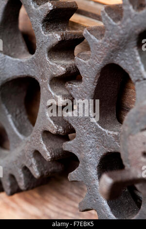 old rusted cog wheel in front of a brick wall Stock Photo - Alamy