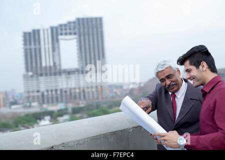 India, Architects and client discussing building plans Stock Photo - Alamy