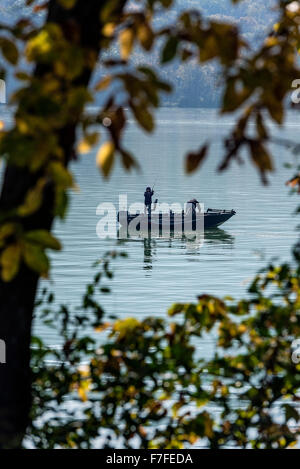 Couple fishing from small motorboat; Swan Lake Provincial Park; British ...