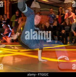 A young break dancer performs on a stage at a break dance competition ...