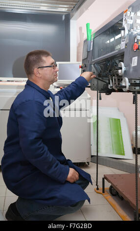Printer working at his new offset machine Stock Photo - Alamy