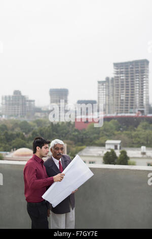 India, Architects and client discussing building plans Stock Photo - Alamy