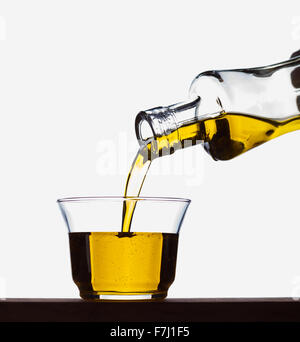 Bottle of virgin olive oil pouring to the spoon close up Stock Photo ...