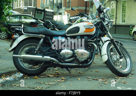 A side on view of a black Triumph Speed Triple motorcycle parked up on ...