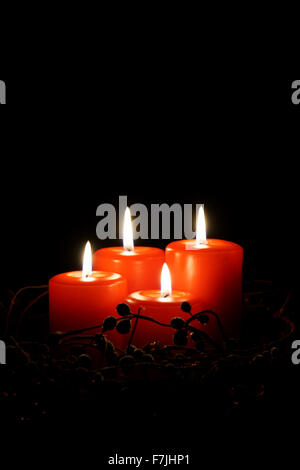 Lit red candles for Advent Season on bokeh lights background Stock ...