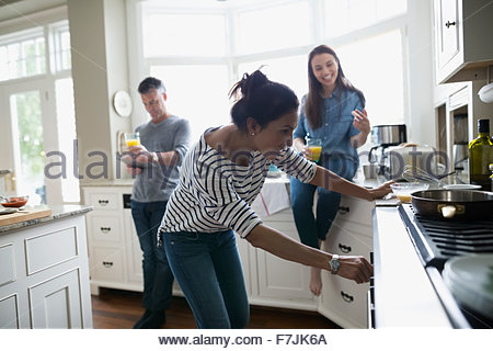 Family cooking breakfast in kitchen Stock Photo - Alamy