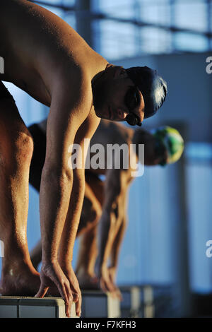 start position race concept with fit swimmer on swimming pool Stock ...