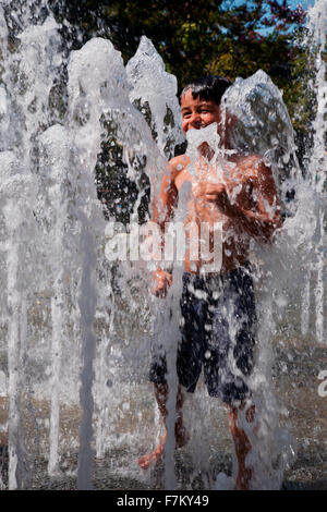A boy plays in a water fountain at the Fundidora Park in Monterrey ...