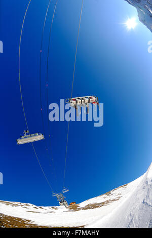Ski lift - happy skiers use vertical transport on ski vacation at sunny ...