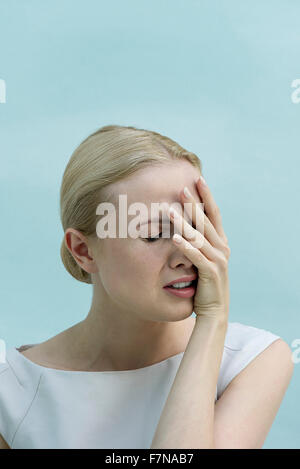 Embarrassed woman covering face with hand on white background Stock ...