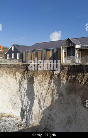 A view of the cliff fall of birling gap beach with people sitting on it ...
