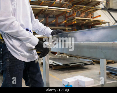 Worker binding metal frames with clamps for welding Stock Photo - Alamy