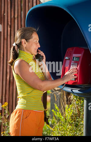Senior woman on the pay phone outdoor Stock Photo - Alamy