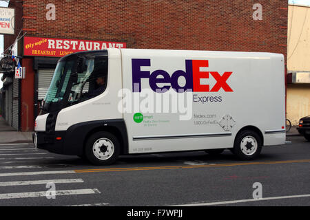 FedEx electric delivery van with sustainability branding parked on city ...