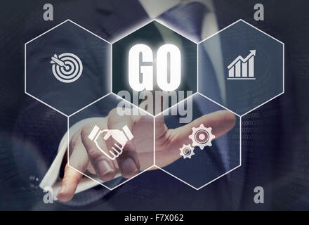 Businessman pressing a Go concept button Stock Photo - Alamy