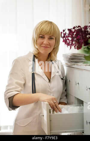 Nurse searching medical chart in clinic Stock Photo - Alamy