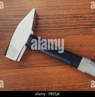 Rusty rough metal claw hammer on vintage wooden board top view ...