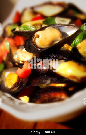 Close up on clams, muscles, shrimp rice and peas cooking in a giant ...
