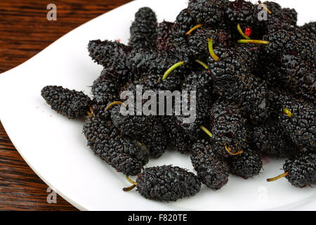 Fresh ripes Mulberry on the plate wood background Stock Photo - Alamy