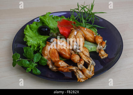 Roasted Frog legs with herbs and spices Stock Photo - Alamy