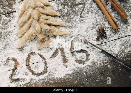 White flour scattered on rustic wooden table with baking background and ...
