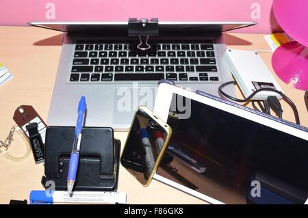 A messy study table of student with electronic devices and study stuffs ...