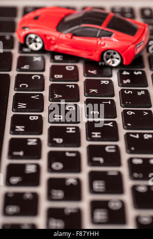 Toy car over laptop keyboard Stock Photo - Alamy