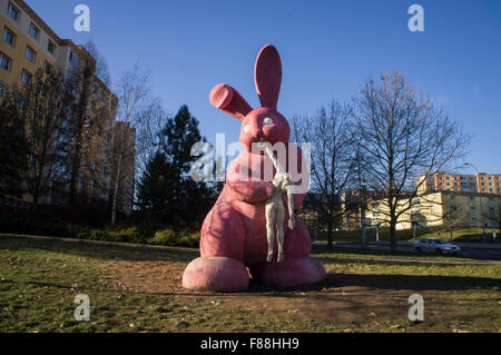 giant pink rabbit eating a headless human body statue Stock Photo - Alamy