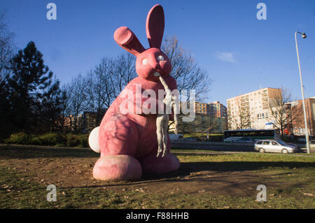 giant pink rabbit eating a headless human body statue Stock Photo - Alamy
